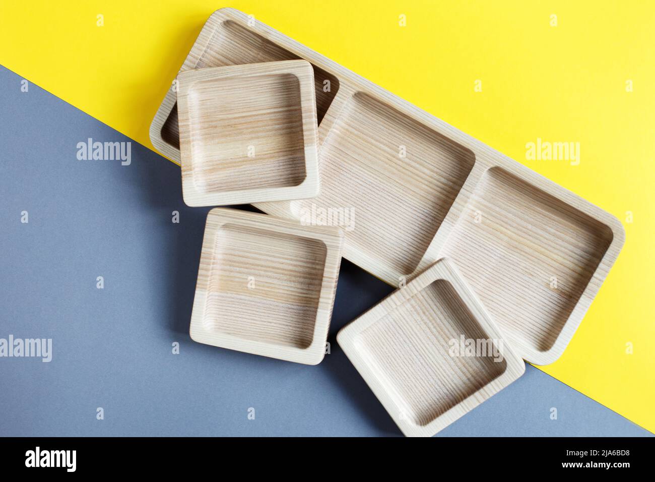 wood empty plates for snack on the color grey and yellow background ...