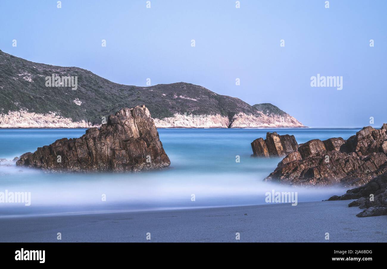 Long exposure photograph at a beach makes the sea silky smooth around ...