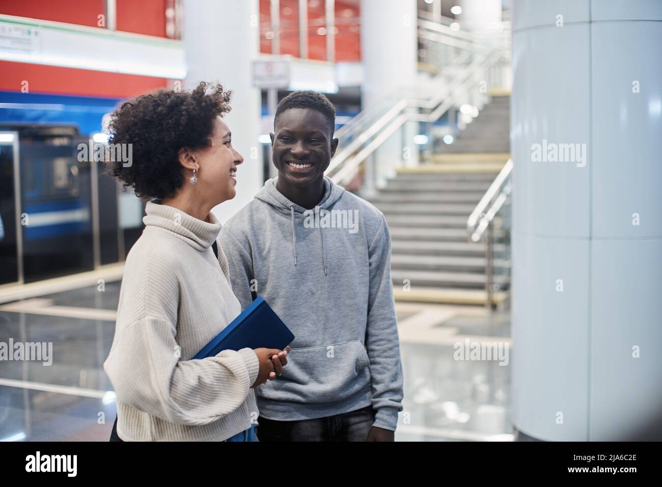 couple of students communicate during a trip to the subway Stock Photo ...