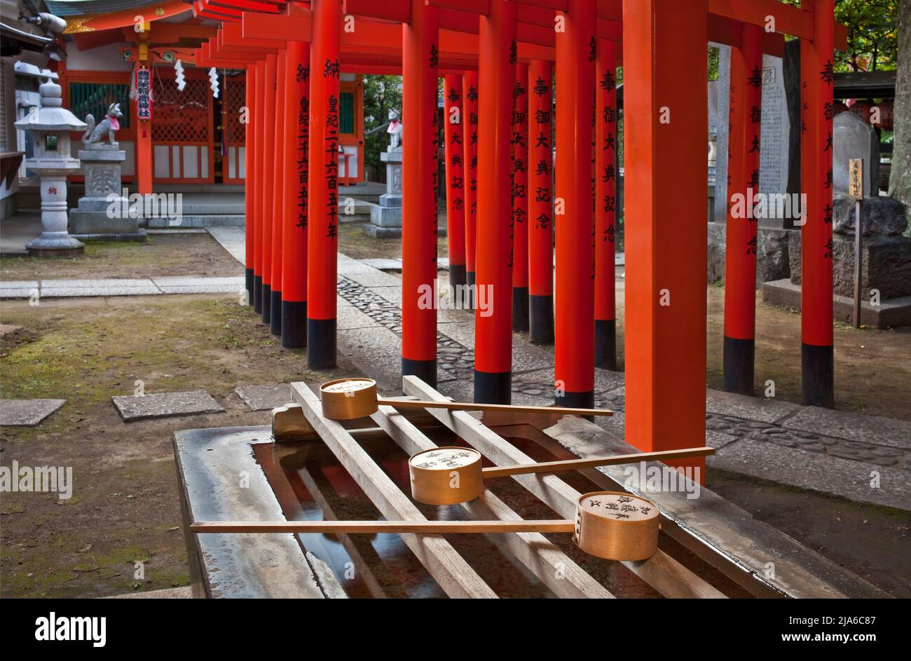 Chōzubachi purifying basin and rows of torii gates at Toyosakainari ...