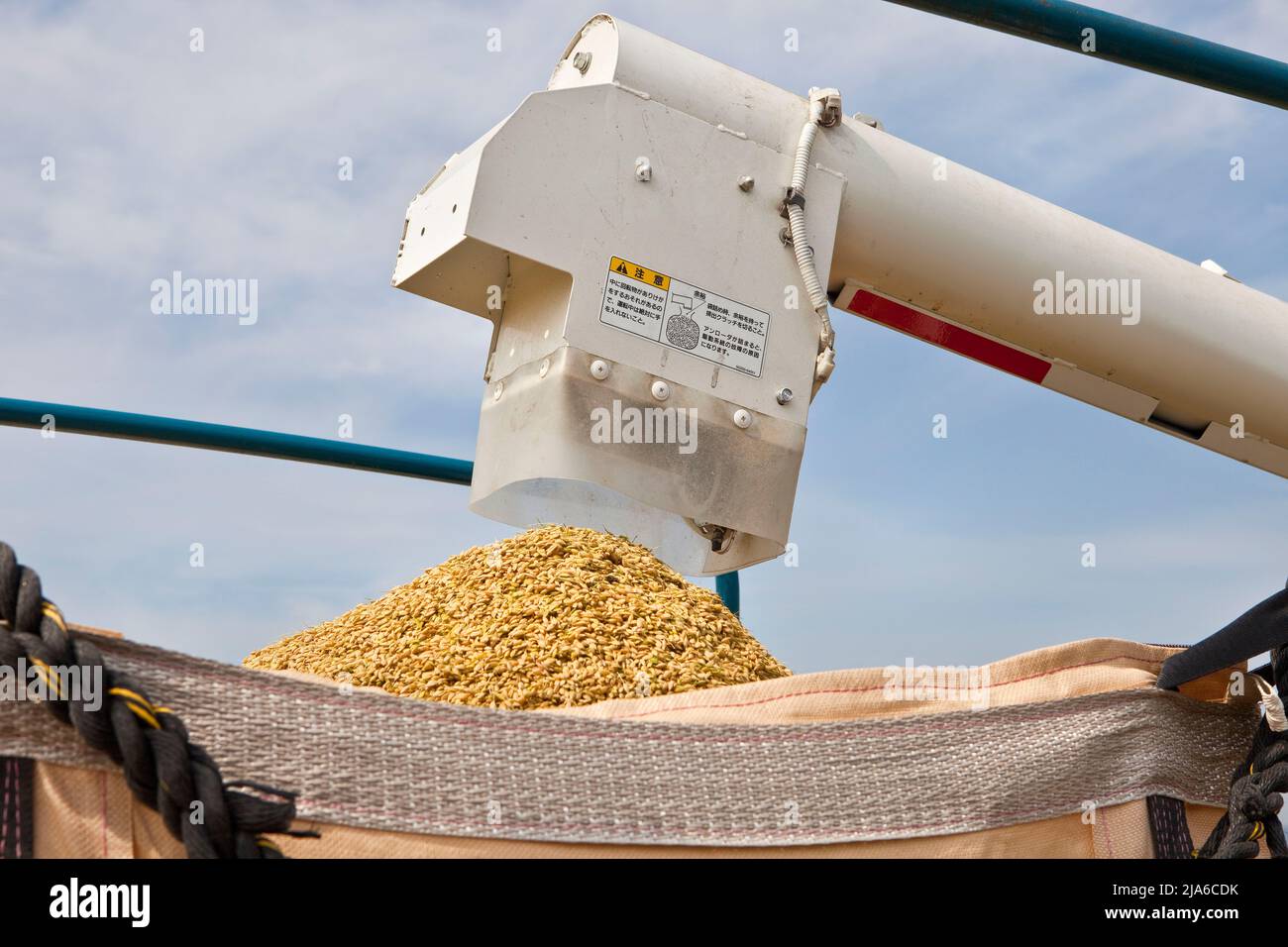 Combine fills hopper with harvested rice in Tosu, Saga, Japan Stock ...