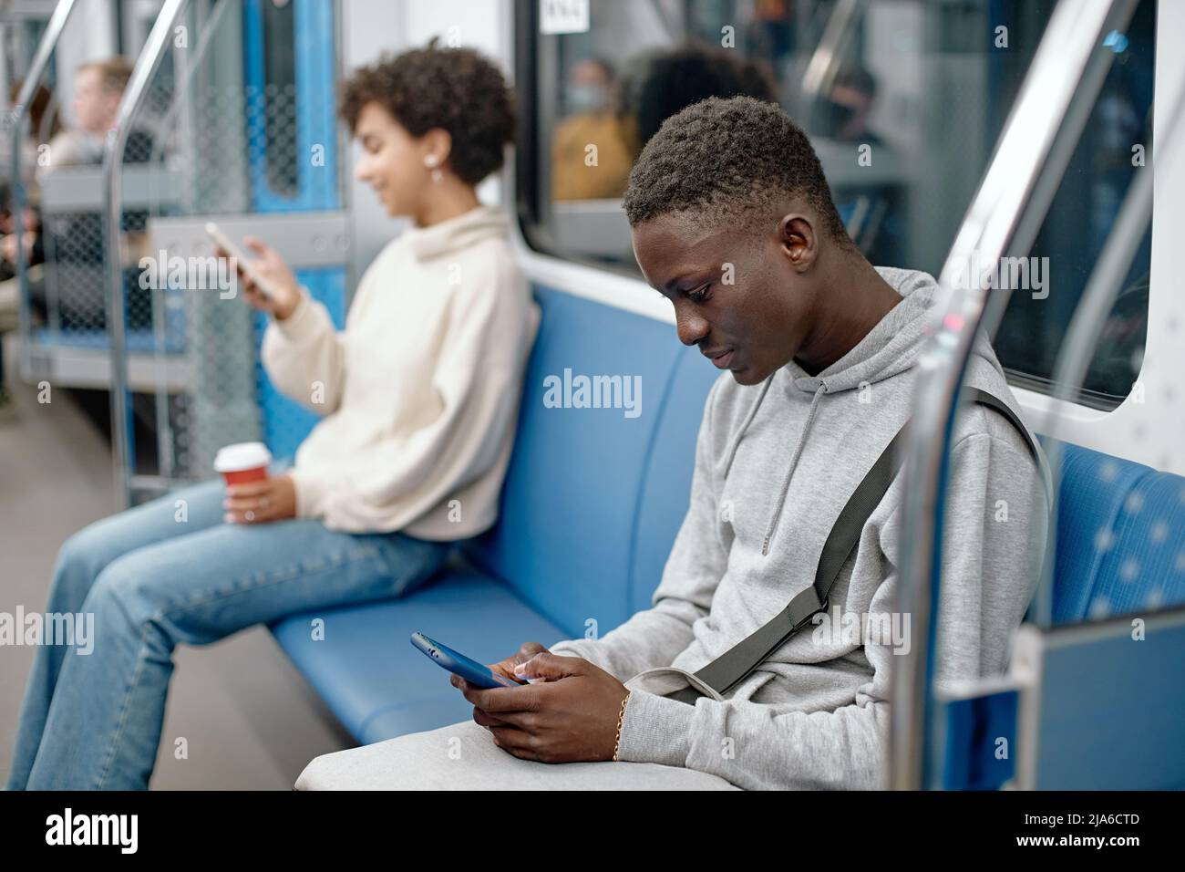 young people with smartphones traveling in the subway Stock Photo - Alamy