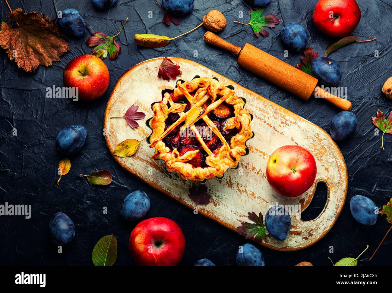 Homemade autumn pies with pear, apple, grapes and plum.Top view Stock ...