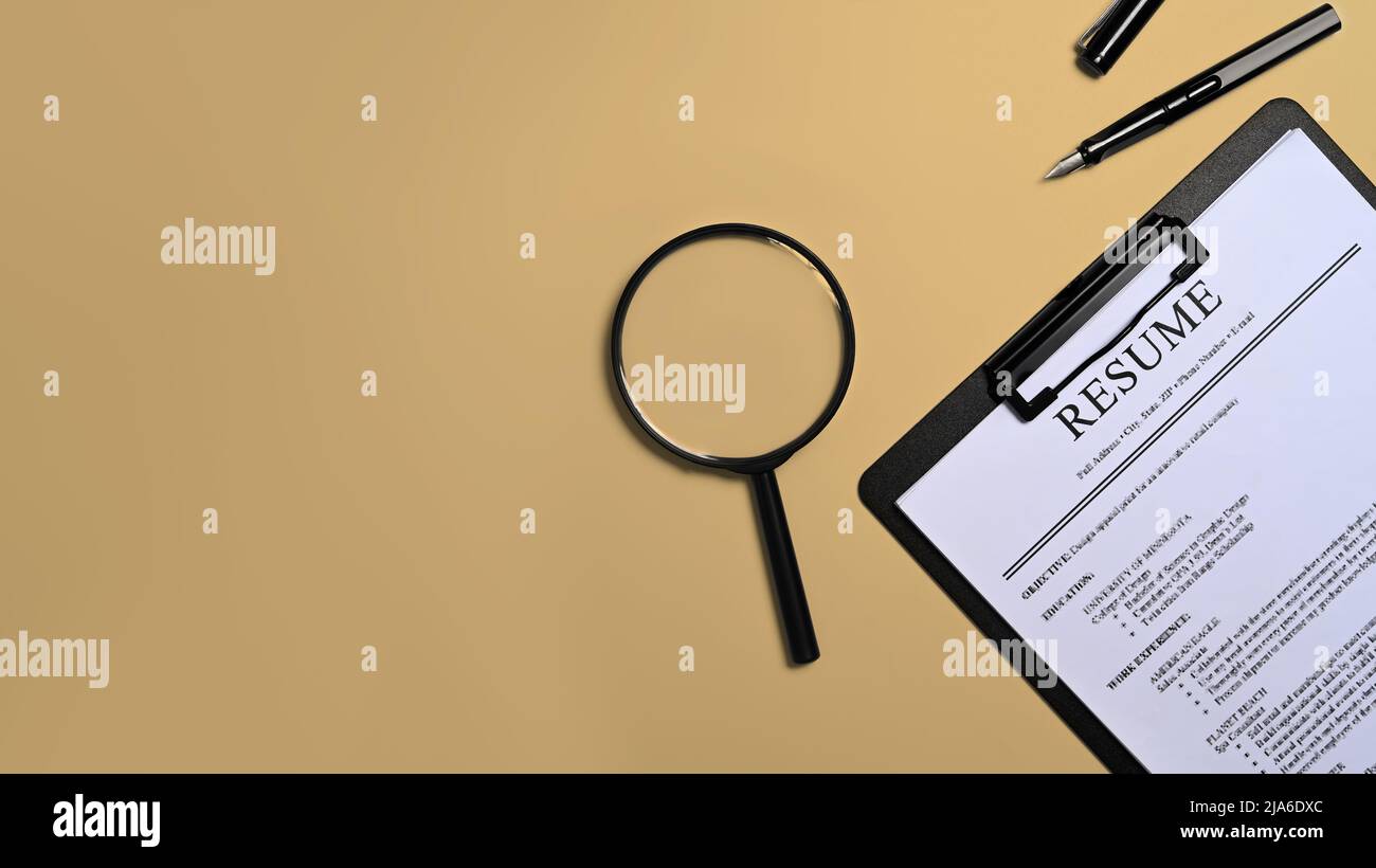 Resumes of applicants and magnifying glass on beige background. Top ...