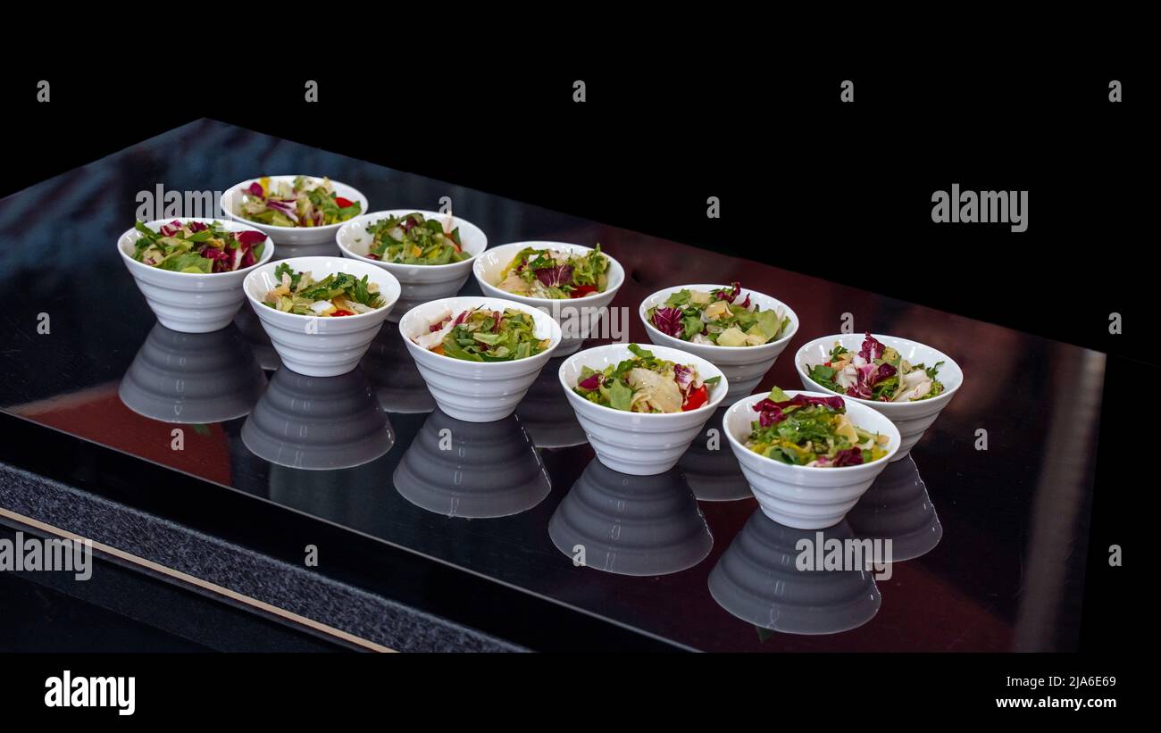 Green vegan salad from green leaves mix and vegetables, side view. set ...