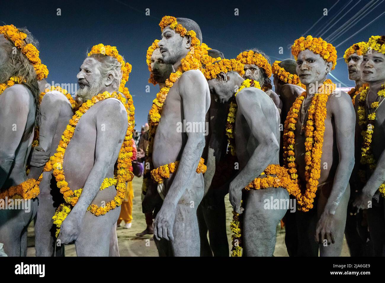 Naga sadhus walk towards the holy waters of the Ganges river during the ...