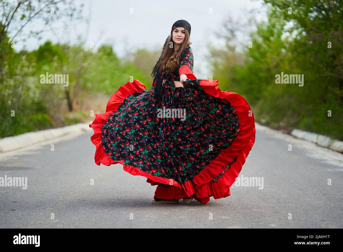 Young beautiful gypsy woman dancing in the middle of the street, in ...