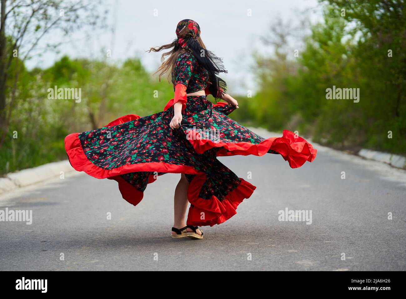 Young beautiful gypsy woman dancing in the middle of the street, in ...