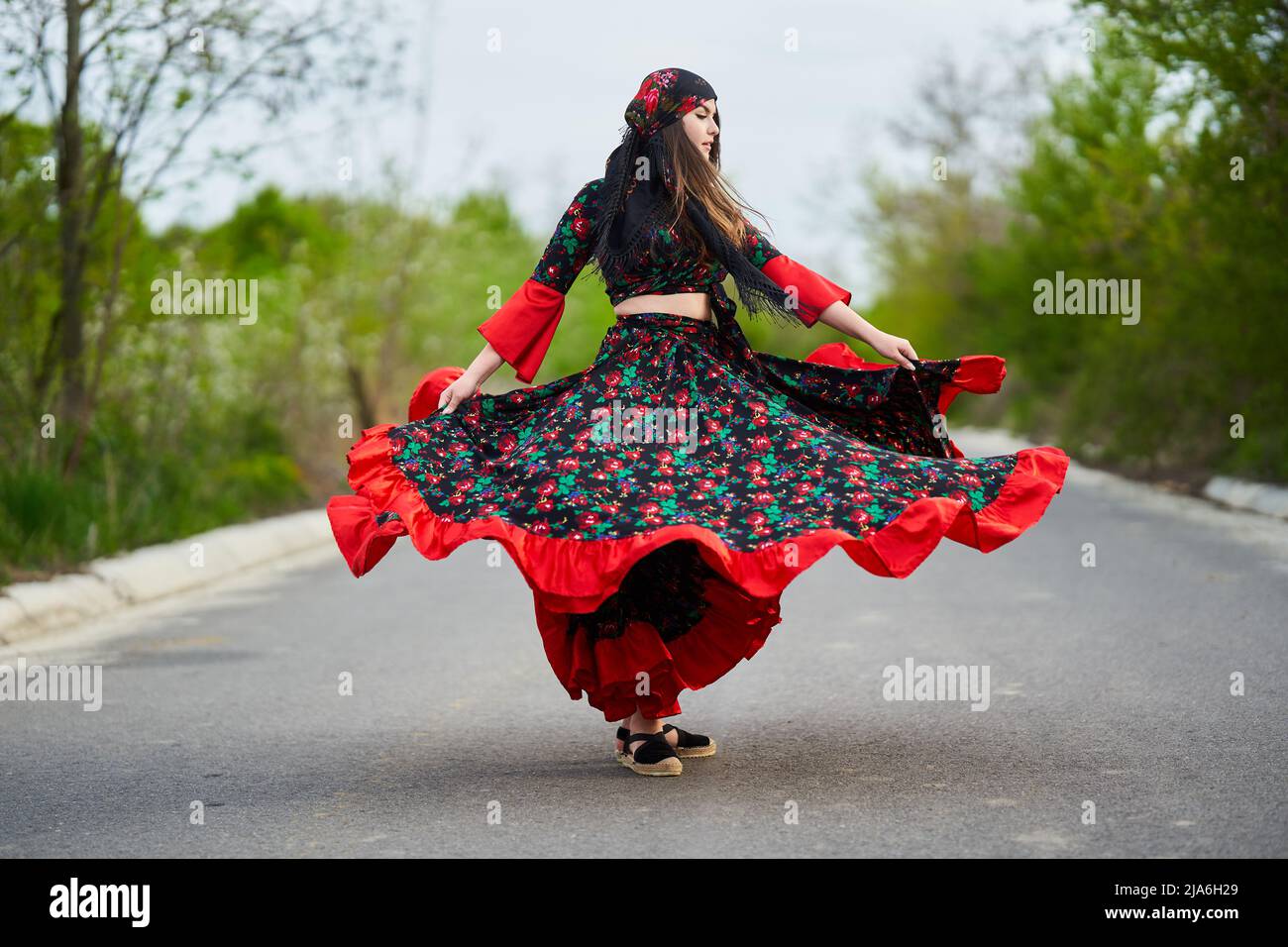 Young beautiful gypsy woman dancing in the middle of the street, in ...