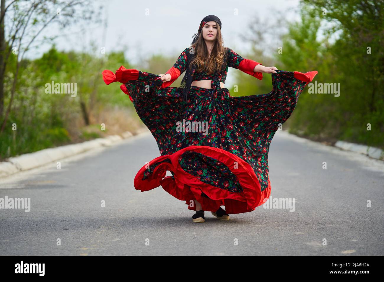 Young beautiful gypsy woman dancing in the middle of the street, in ...