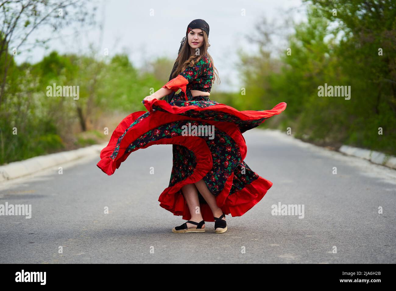 Young beautiful gypsy woman dancing in the middle of the street, in ...