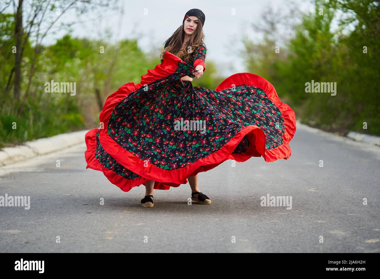 Young beautiful gypsy woman dancing in the middle of the street, in ...