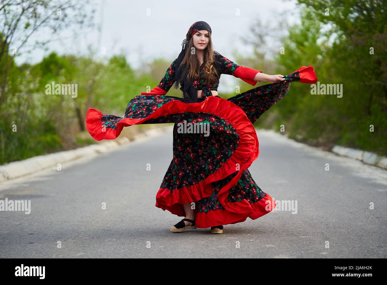 Young beautiful gypsy woman dancing in the middle of the street, in ...
