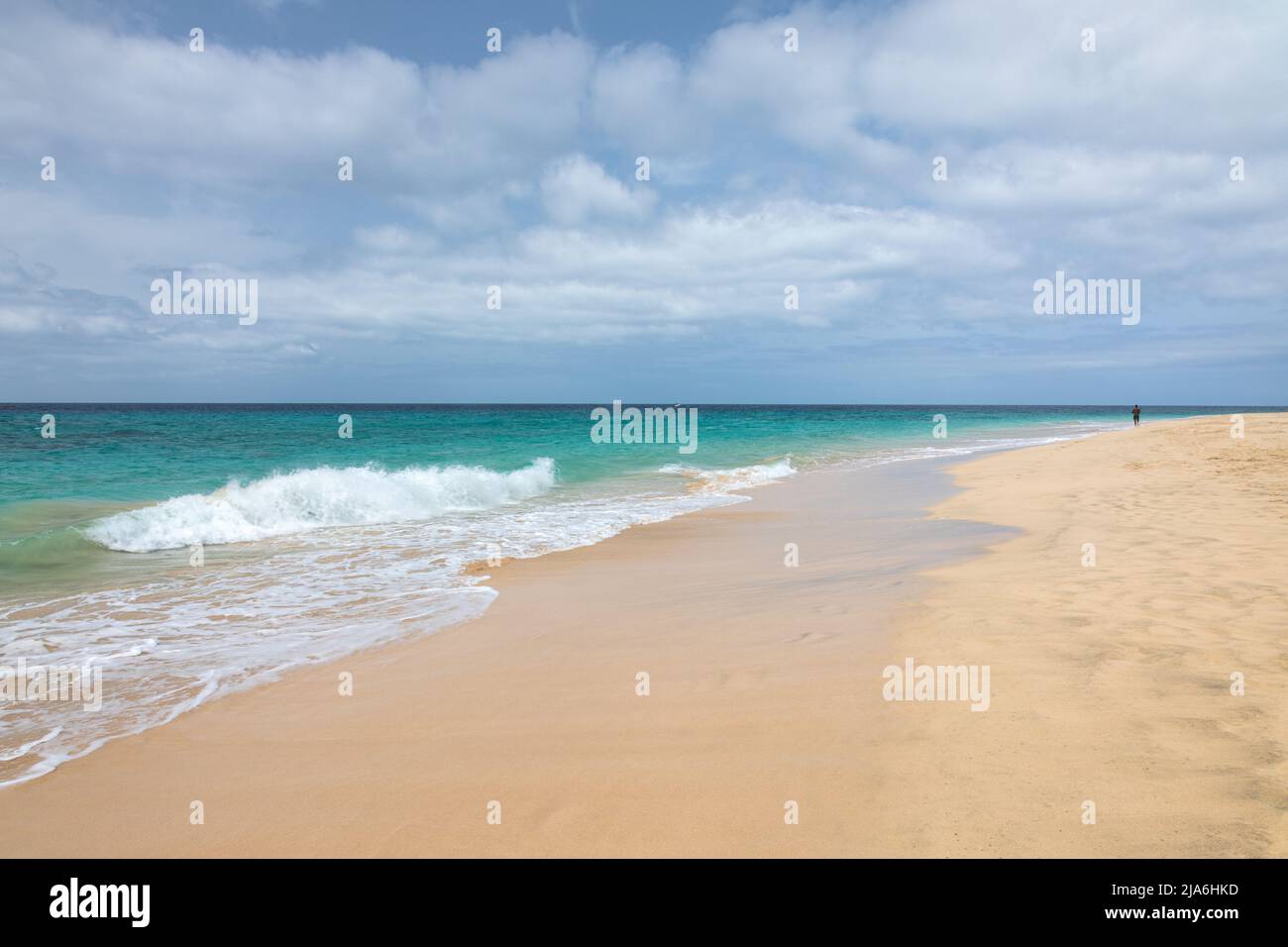 A lone figure on the idyllic empty white sandy beach of Ponta Preta ...