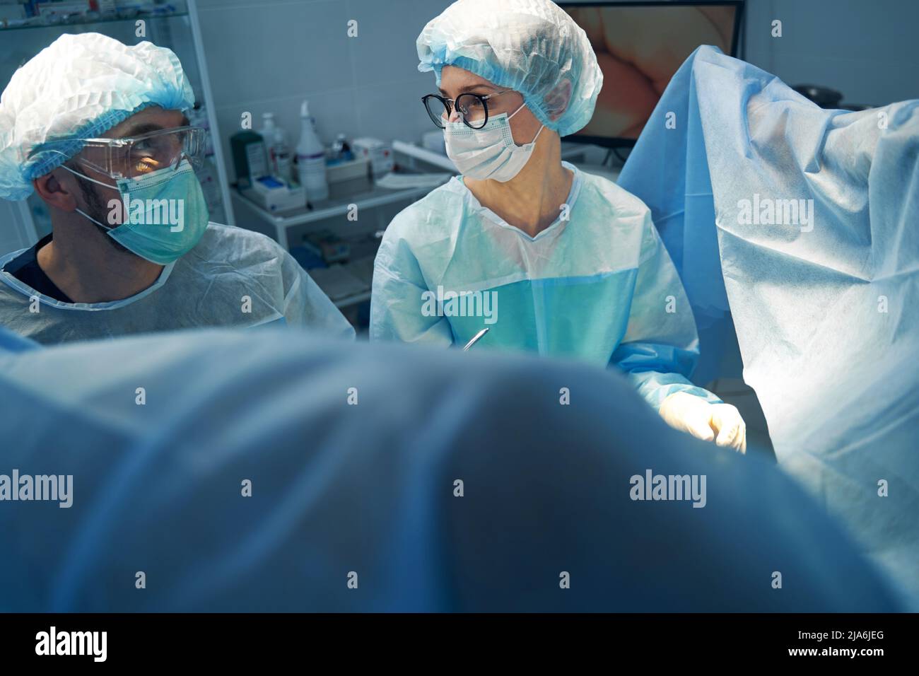 Nurse and doctor exchanging looks during surgical procedure Stock Photo ...
