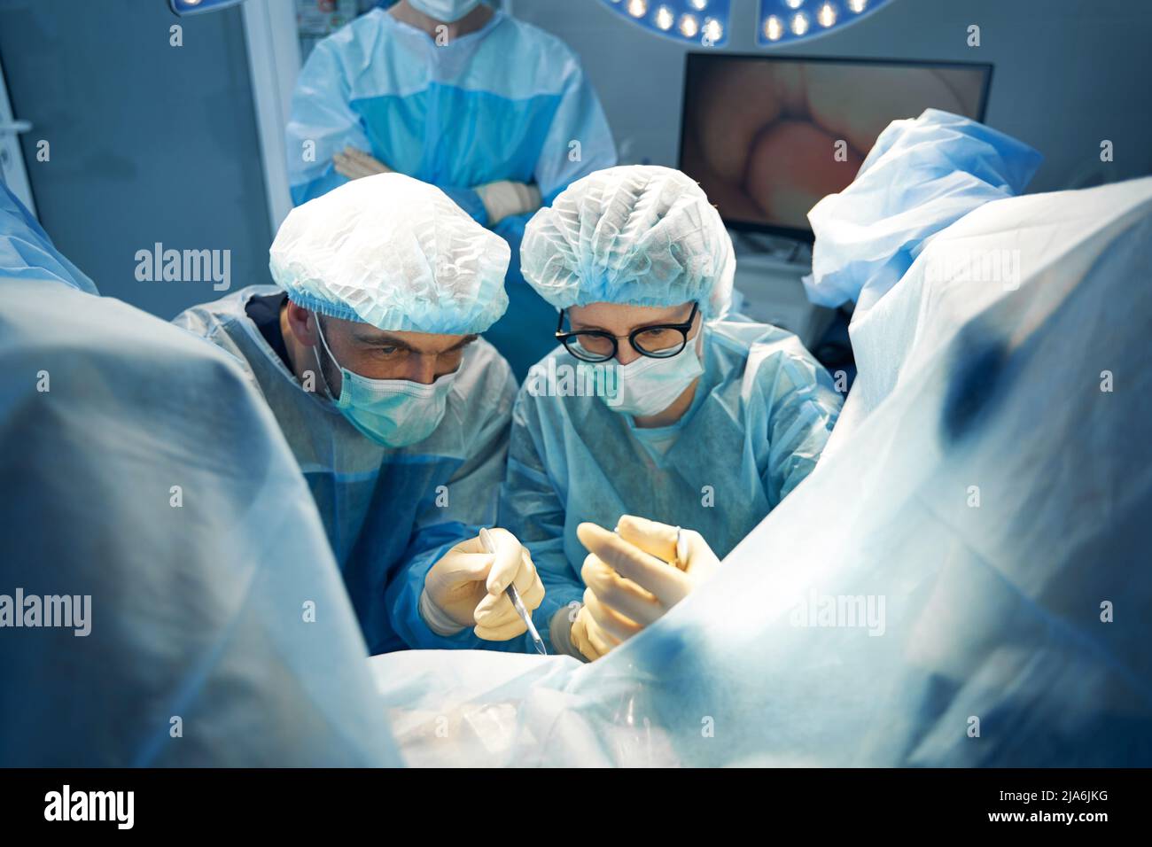 Man surgical expert using scalpel for making tissue incision while ...