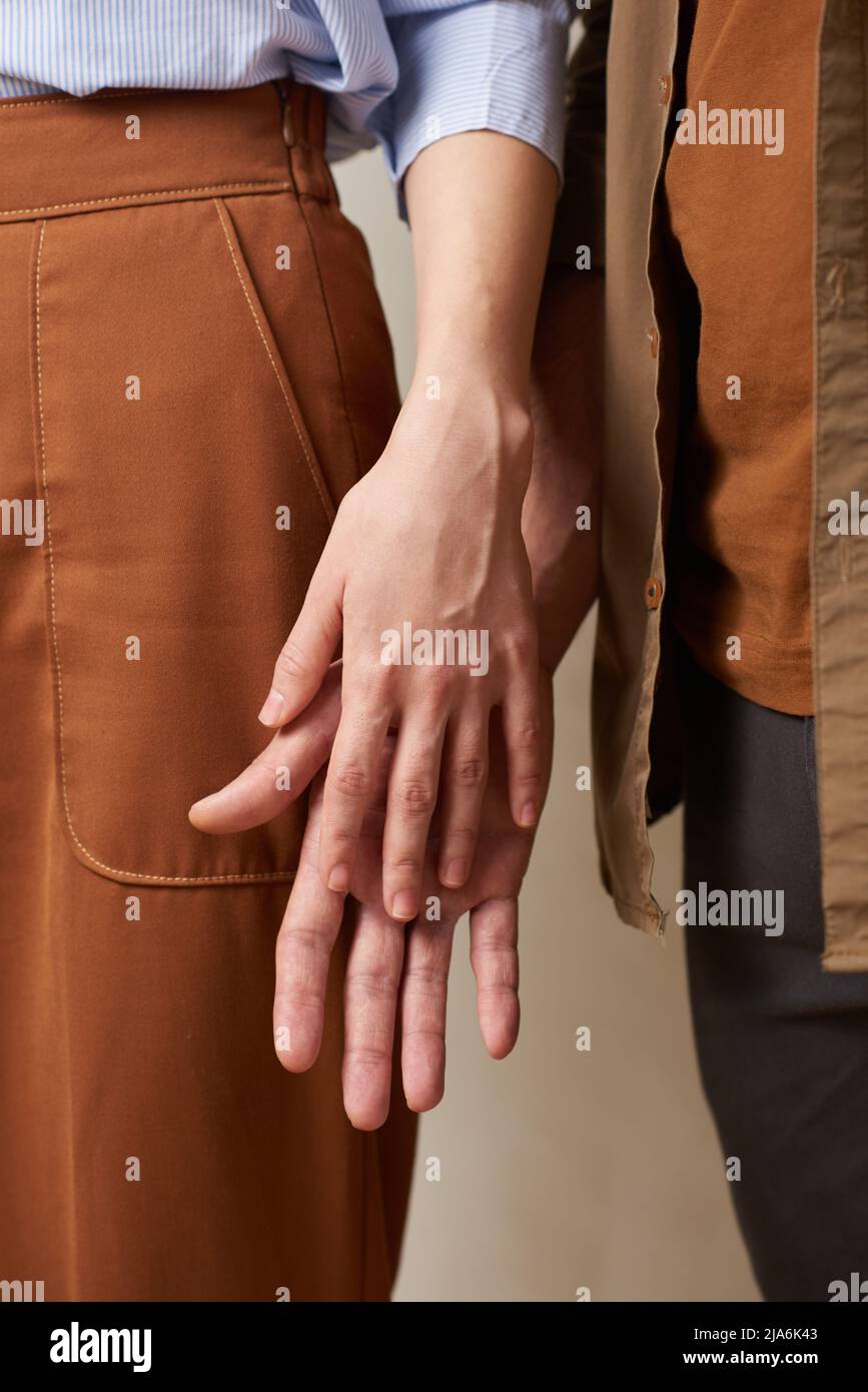 Close-up studio shot unrecognizable young man and woman standing close ...
