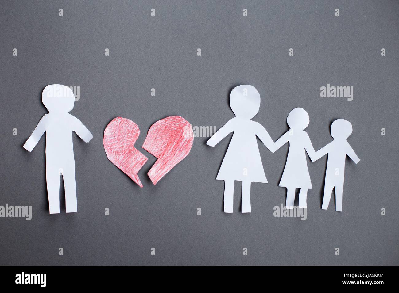 Paper chain cut family with broken heart on gray background. Divorce ...