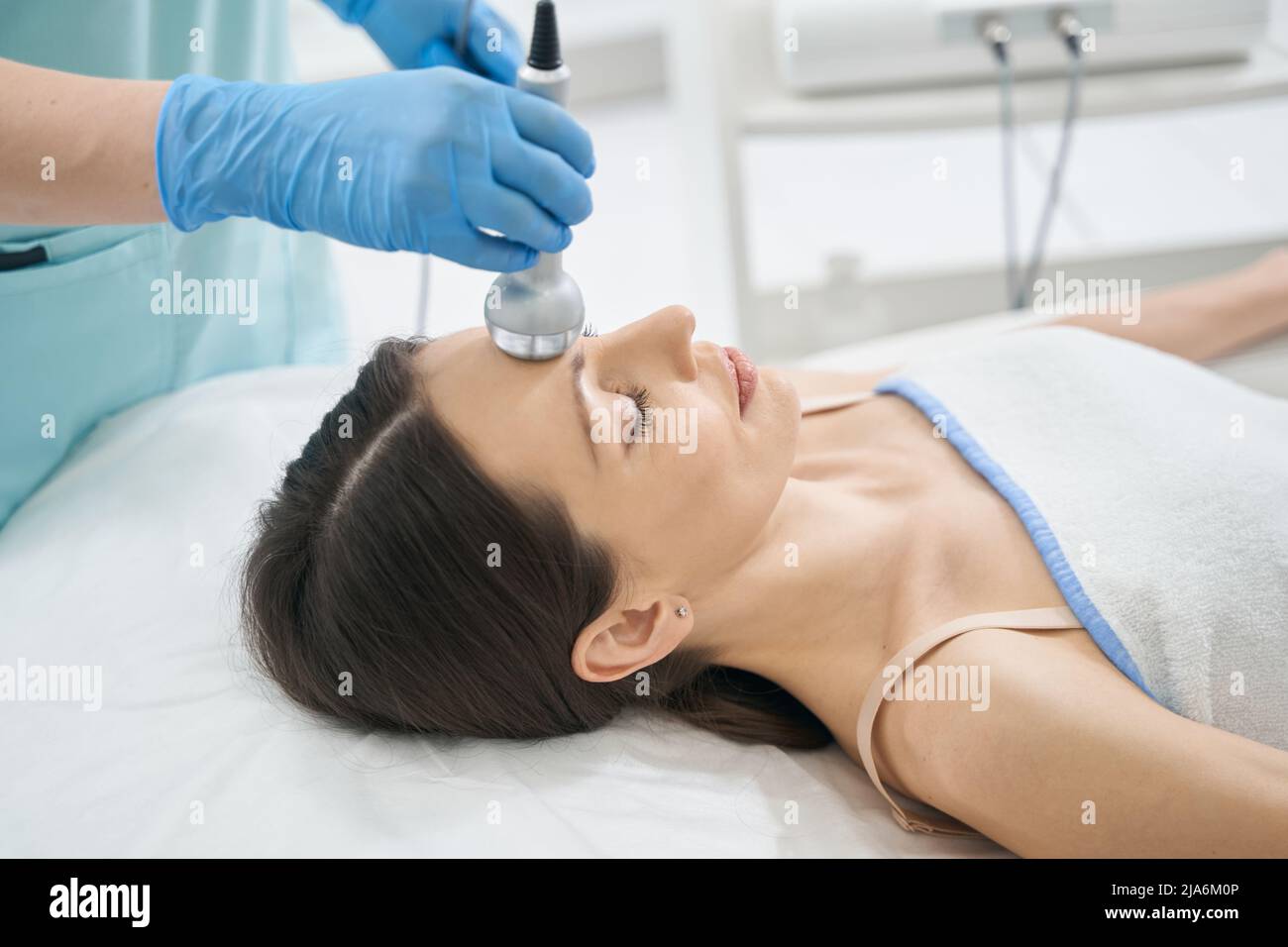 Woman getting forehead skin lifting with RF method Stock Photo - Alamy