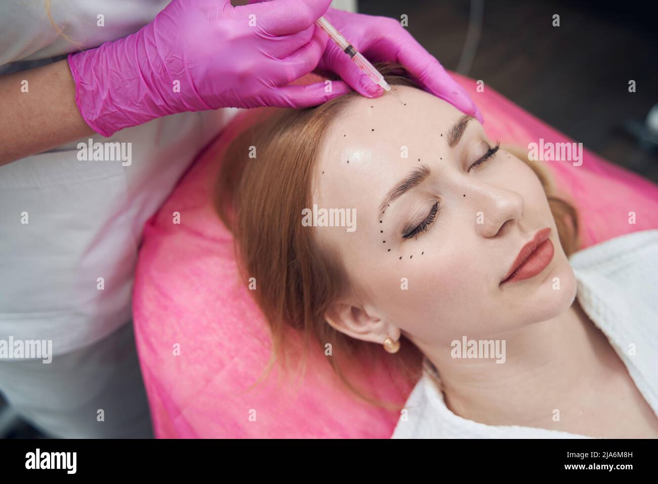 Female lying on cosmetology chair and receiving beauty injections Stock ...