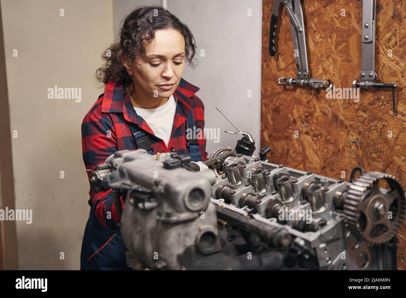 Woman auto mechanic fixing car engine at service station Stock Photo ...