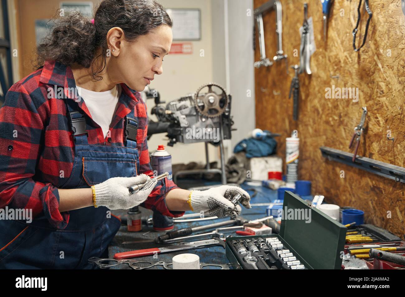 Female auto mechanic choosing car parts in garage Stock Photo - Alamy