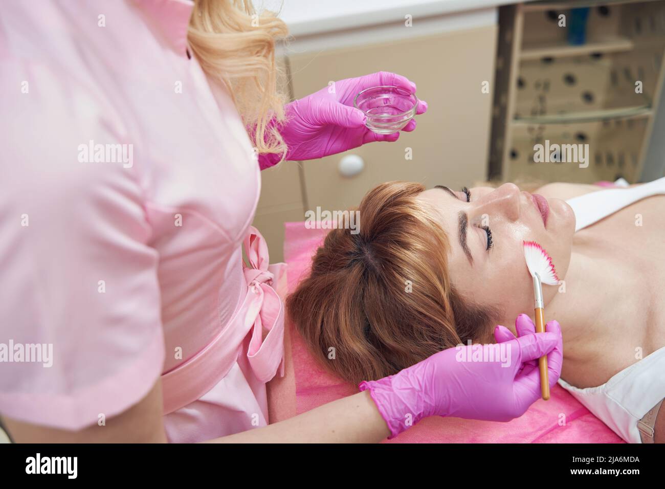 Pretty Caucasian woman is getting peeling procedure in aesthetic center ...