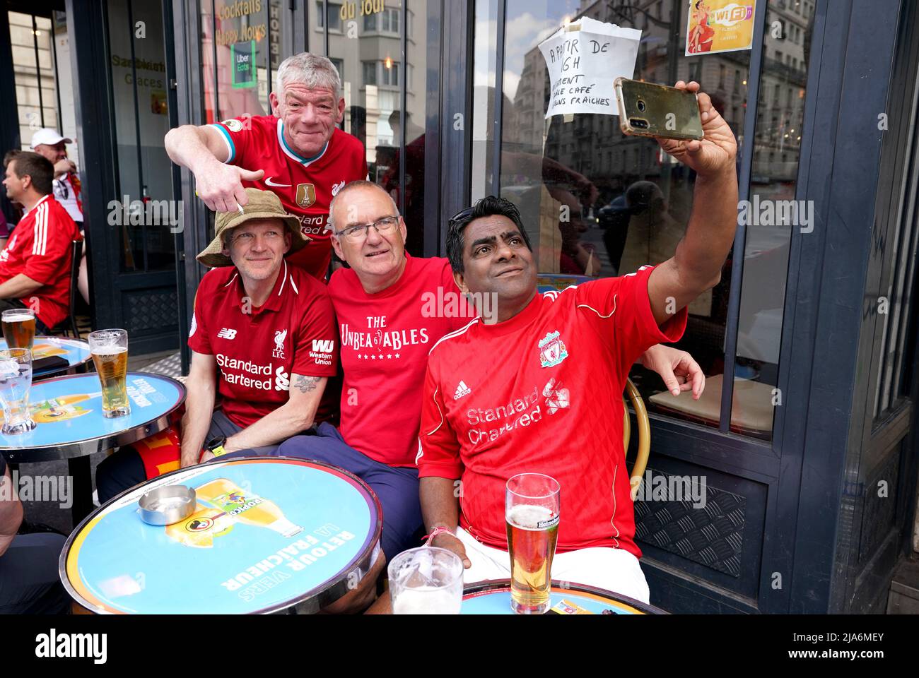 Liverpool fans take a selfie at a cafe ahead of the UEFA Champions ...