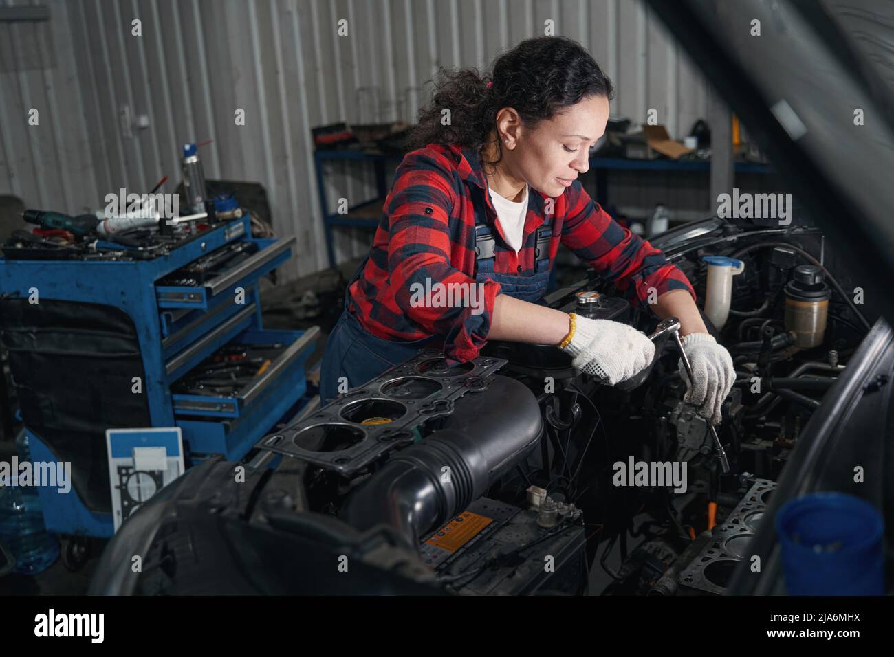 Female auto mechanic repairing car in automobile garage Stock Photo - Alamy