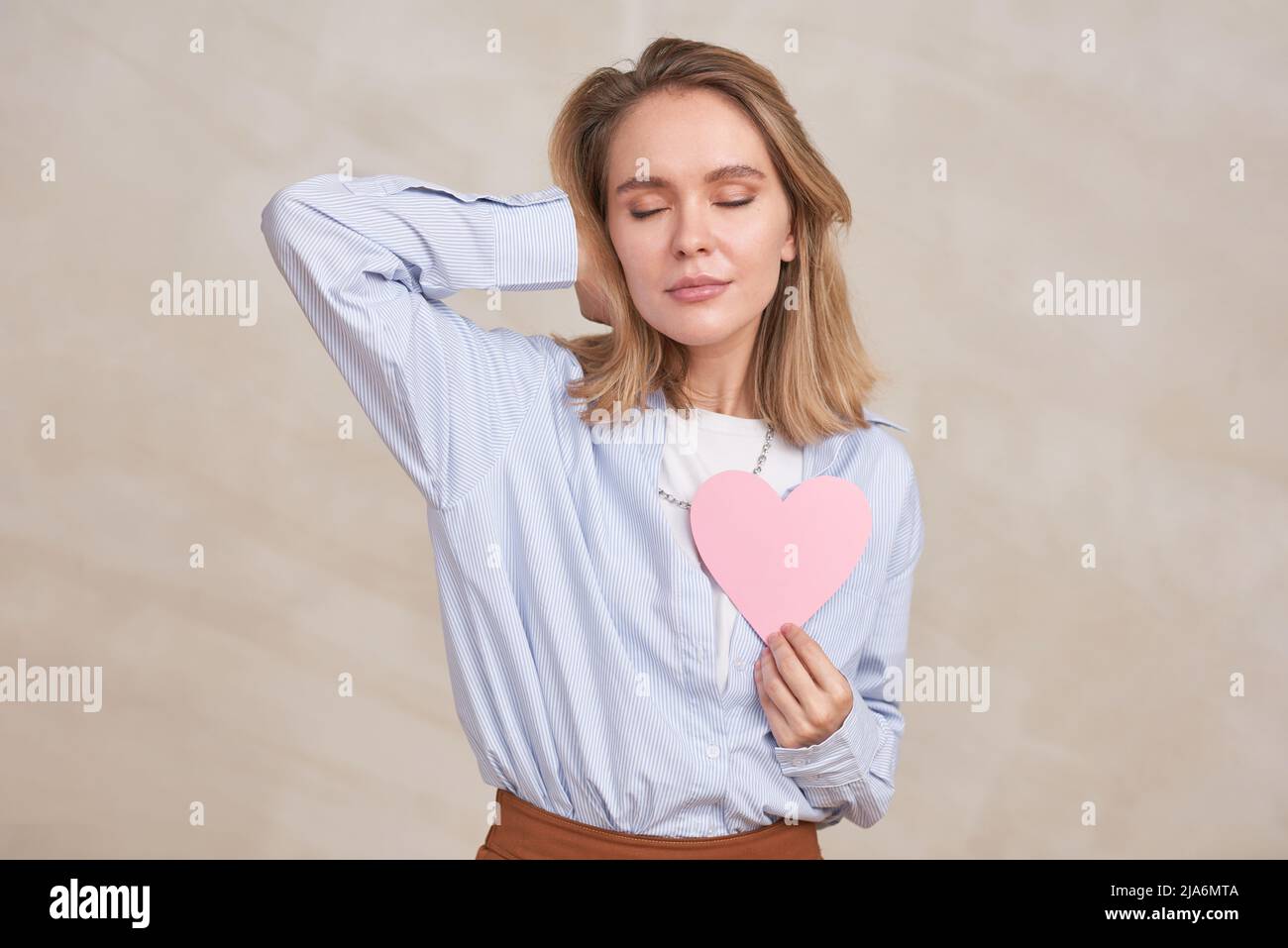 Horizontal medium portrait of young blond woman wearing casual outfit ...