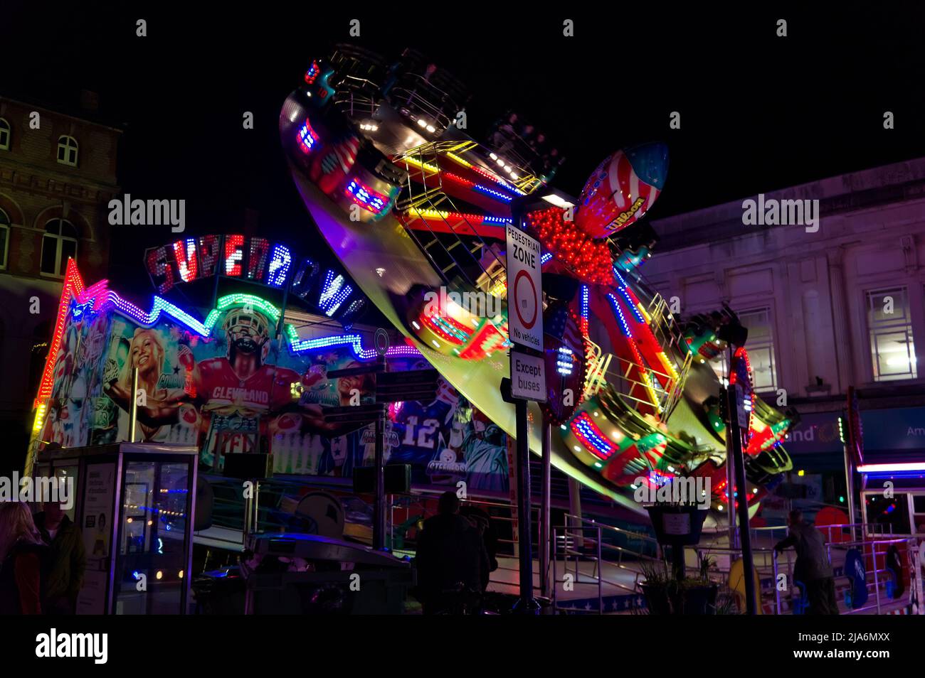 People riding a spinning fair ride at night with motion blur Stock ...