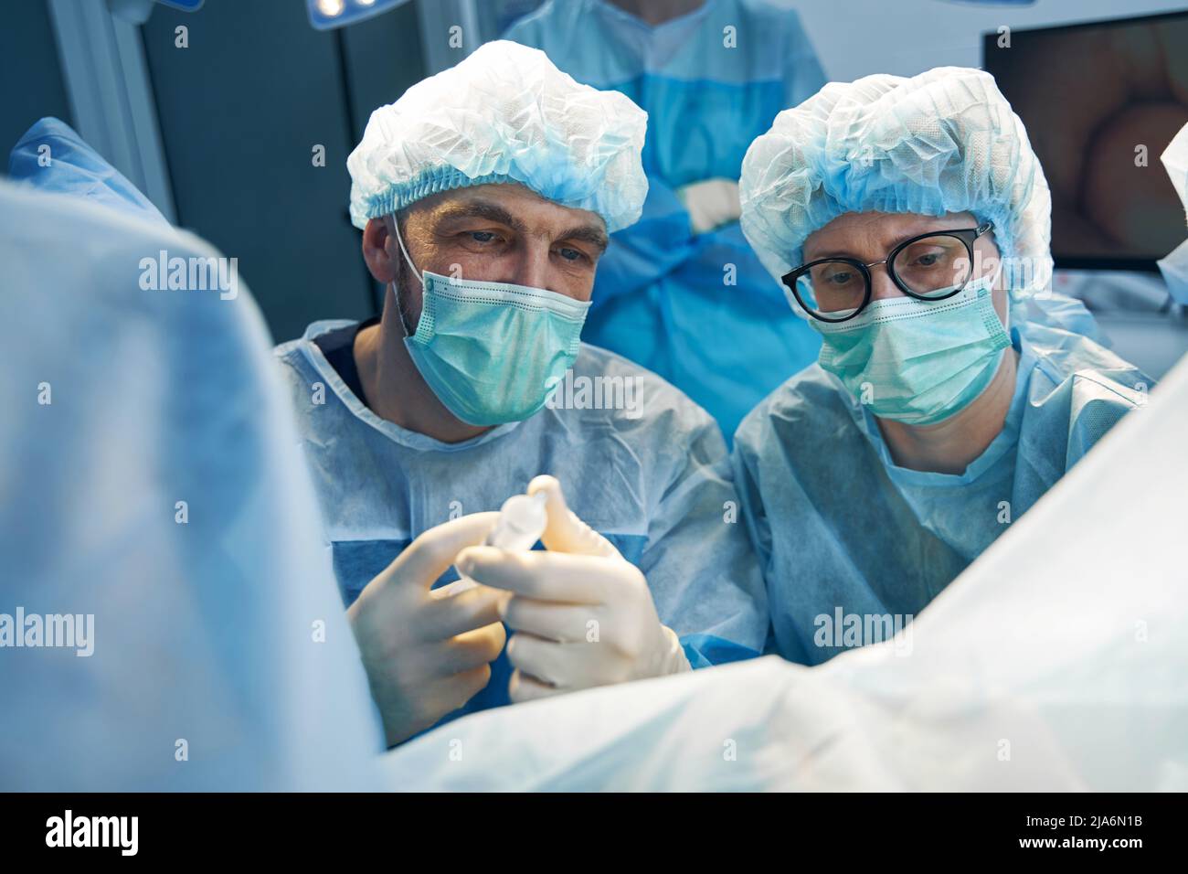 Mature surgeon getting ready to make injection with syringe Stock Photo ...