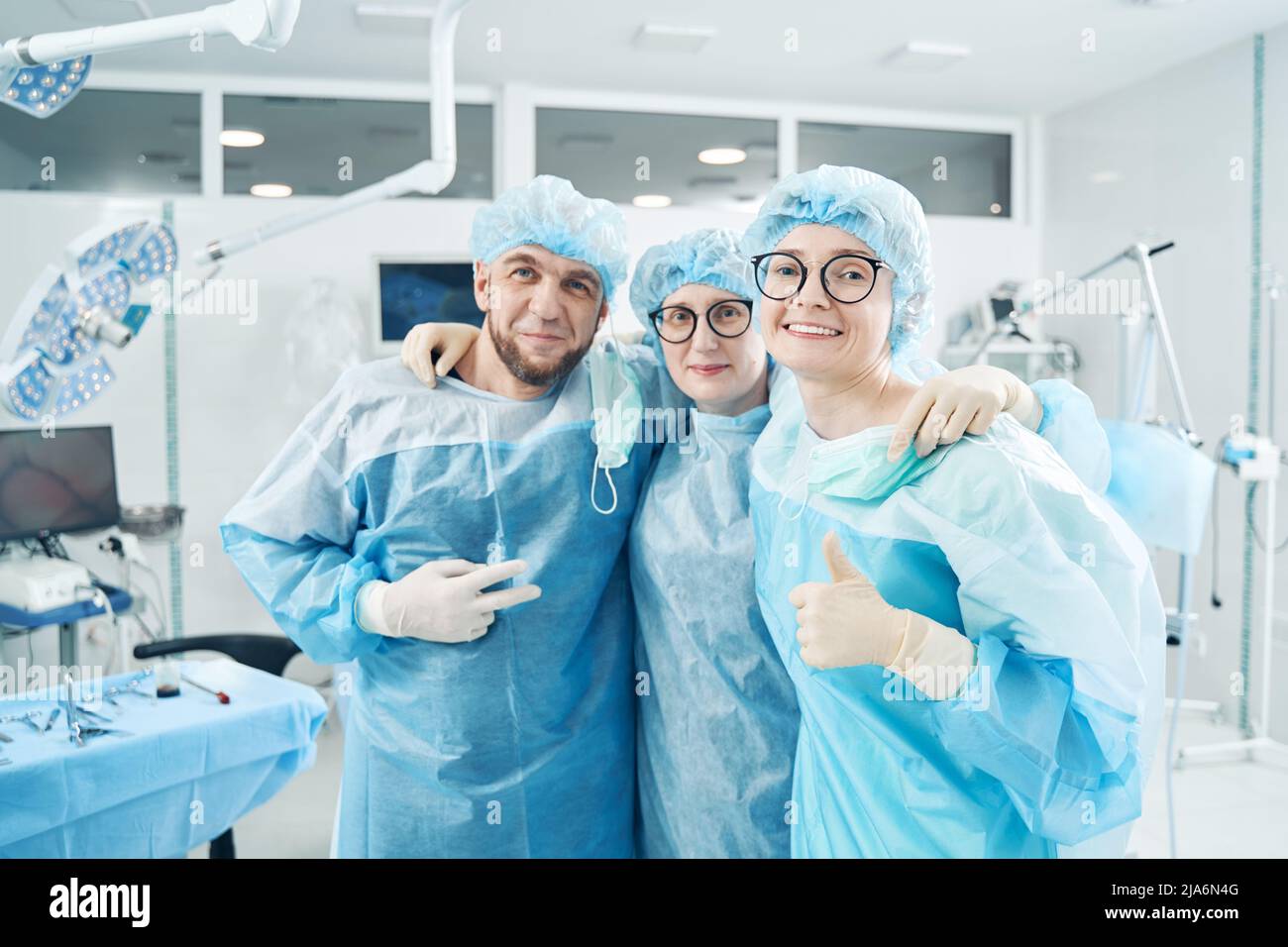 Two female doctors and male surgeon posing for photo Stock Photo - Alamy