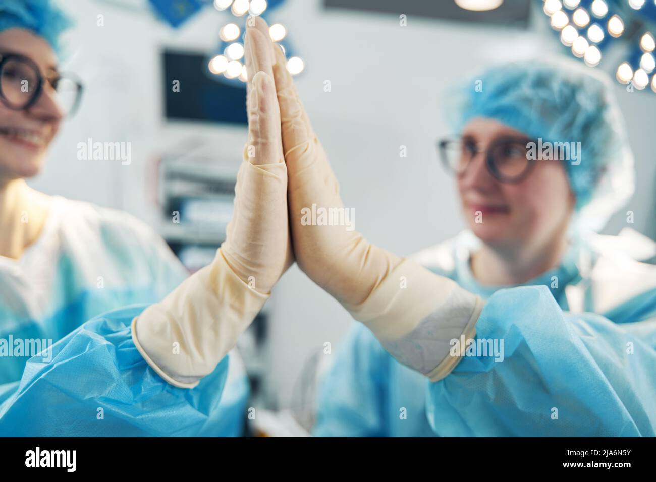 High five of two female nurses in medical office Stock Photo - Alamy