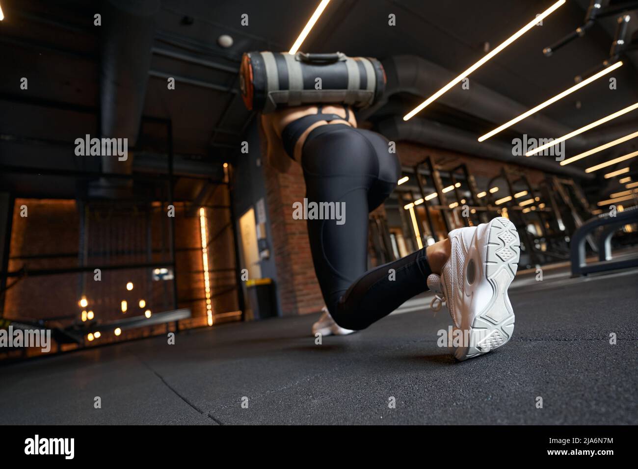 Female athlete doing lunge during gym workout Stock Photo - Alamy