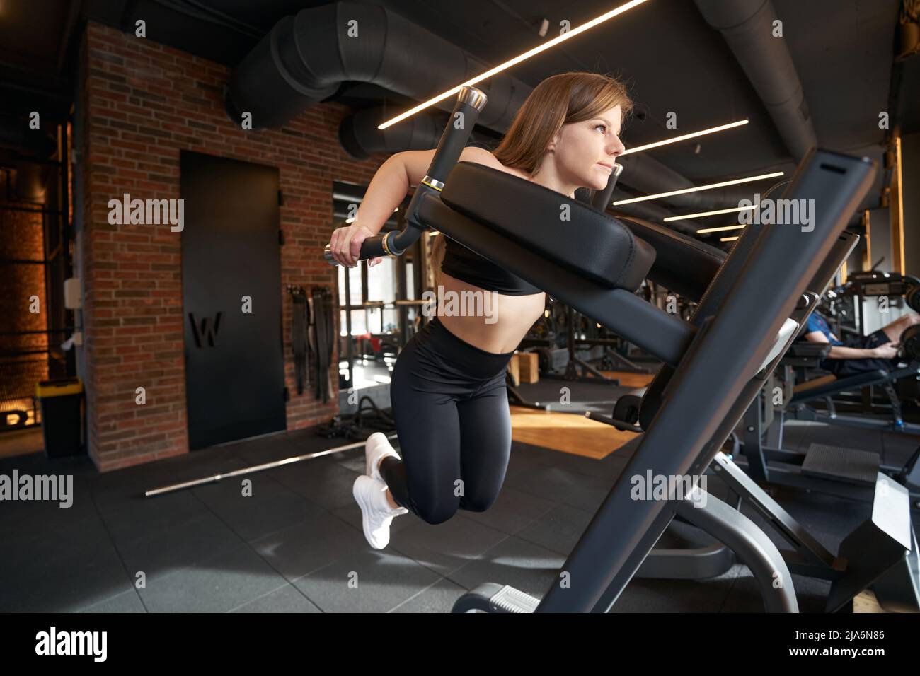 Athletic woman performing push-ups during gym workout Stock Photo - Alamy