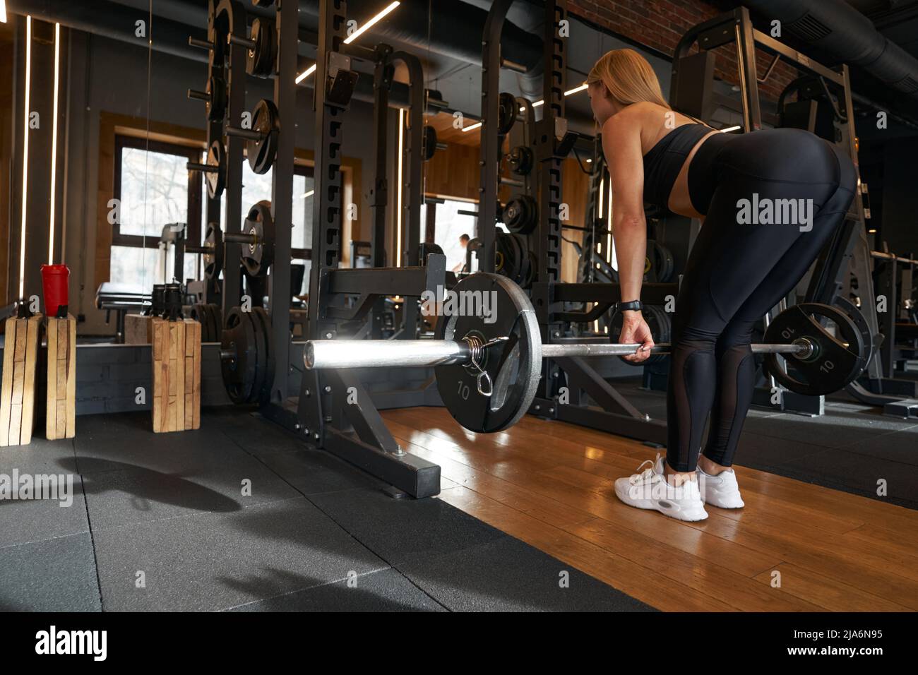 Strong athletic lady performing deadlift exercise indoors Stock Photo ...