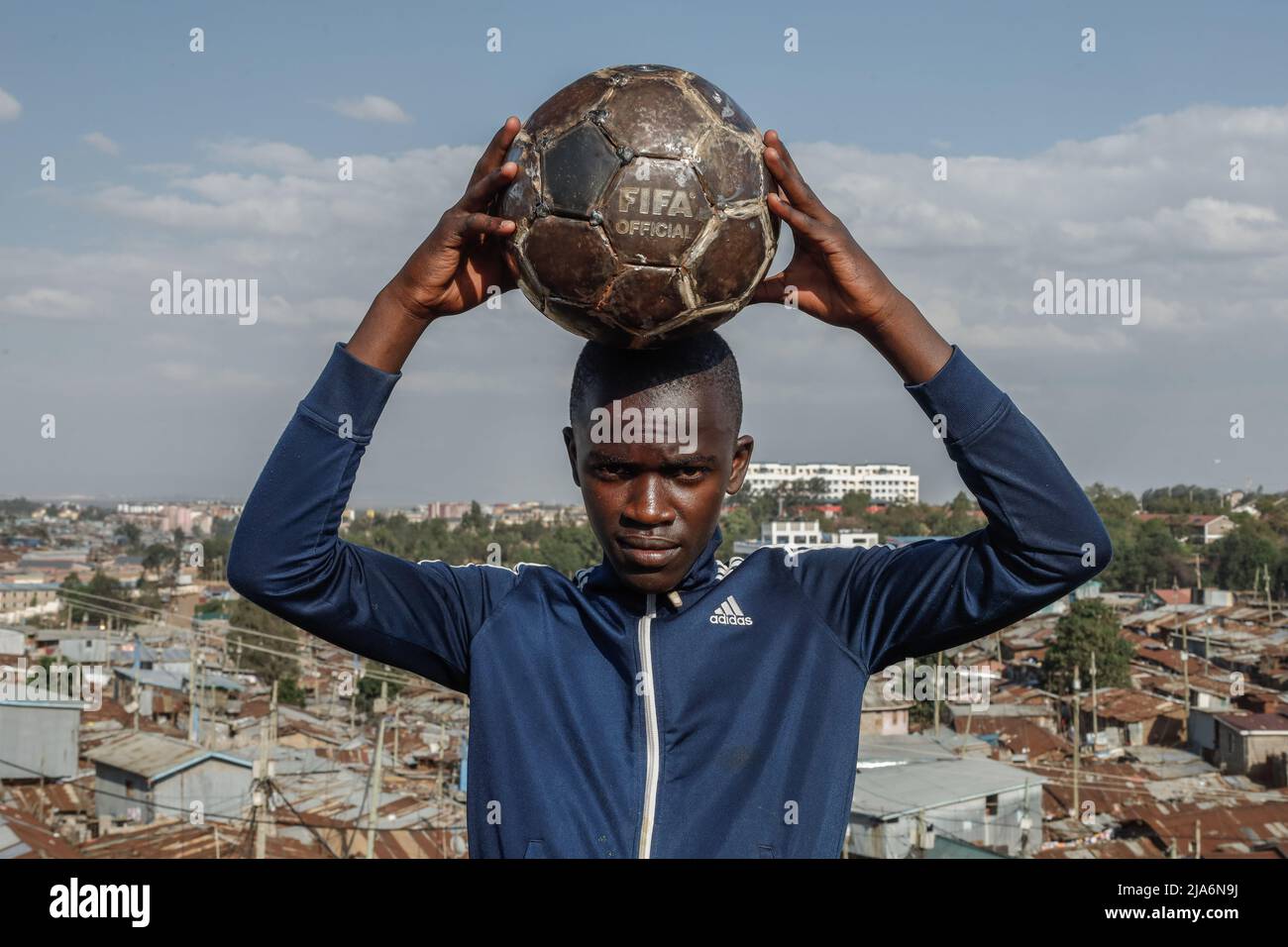 Louis Otieno (Denilso) takes a posture carrying a metalic Fifa Soccer ...