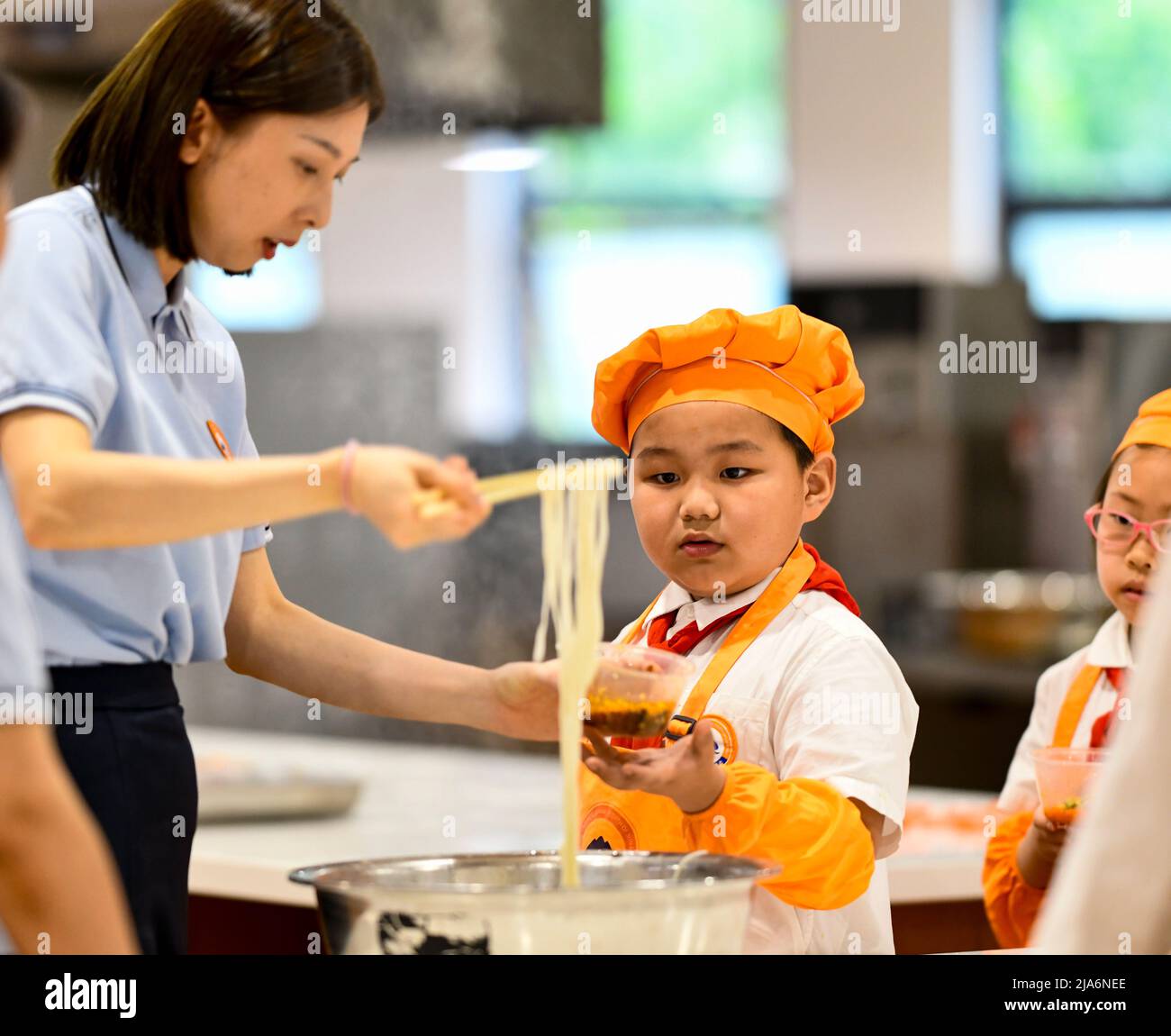 Chongqing. 26th May, 2022. A student prepares to taste the noodles made ...