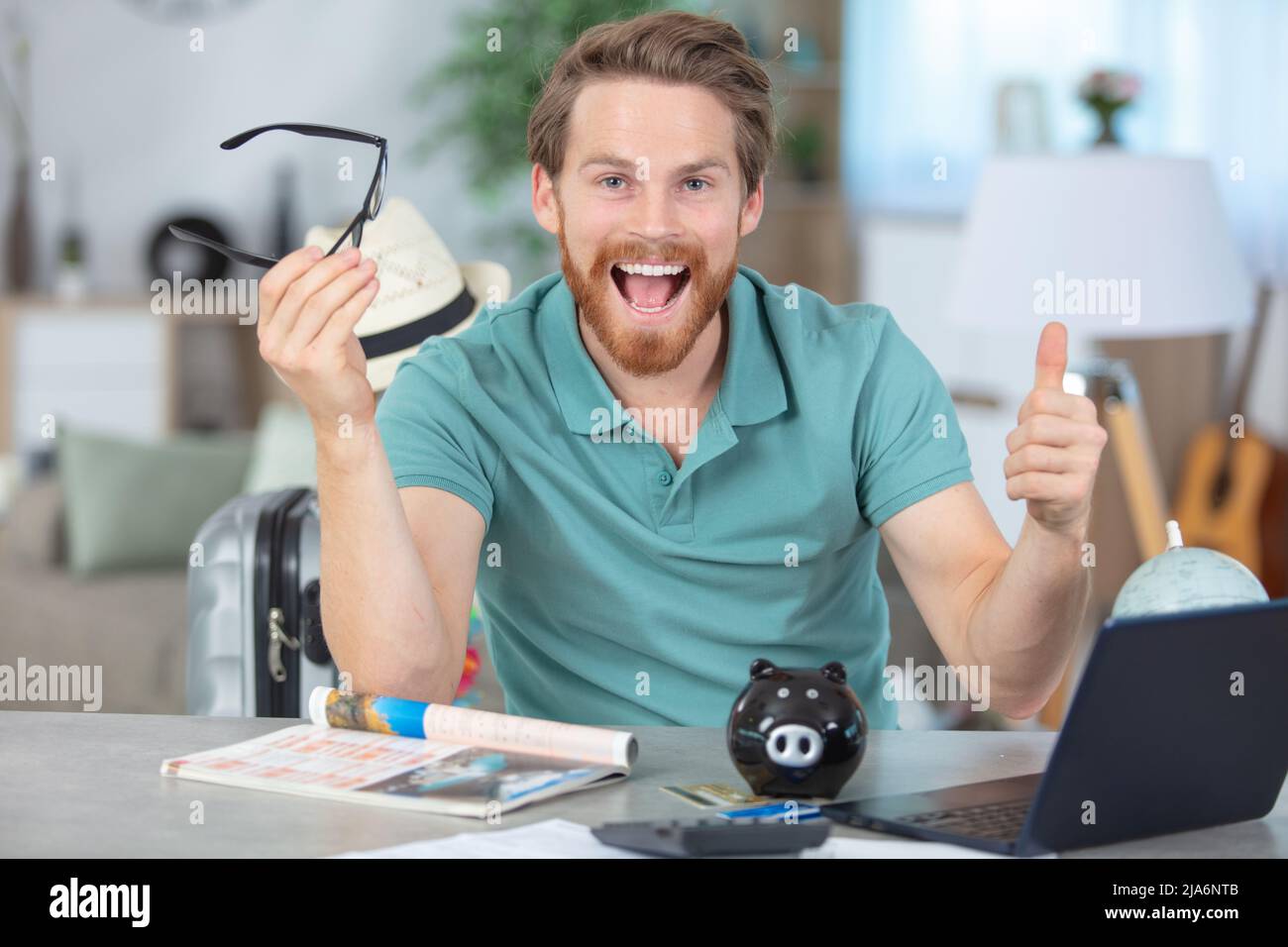 happy man doing bills and saving money Stock Photo - Alamy