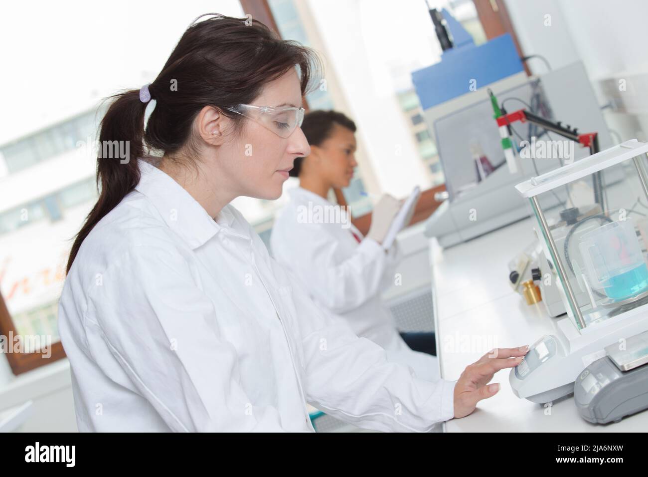 beautiful woman scientist in her lab performing chemistry experiments ...