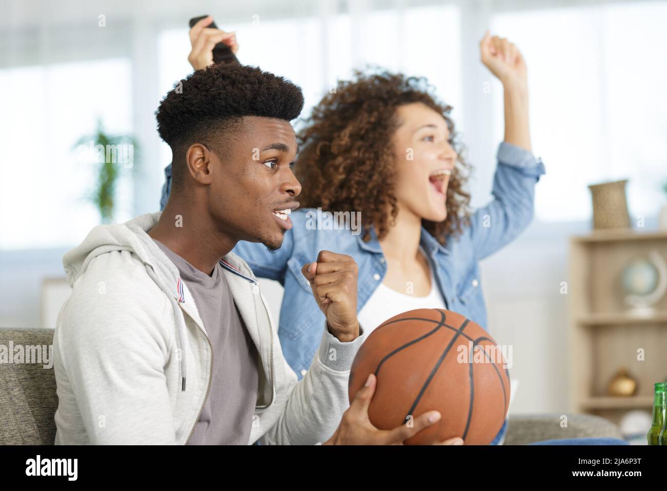 Young couple watching basketball hi-res stock photography and images ...