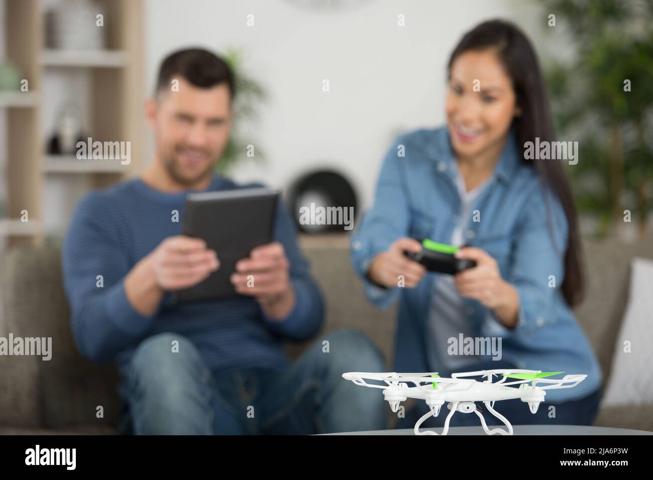 happy couple using modern drone Stock Photo - Alamy