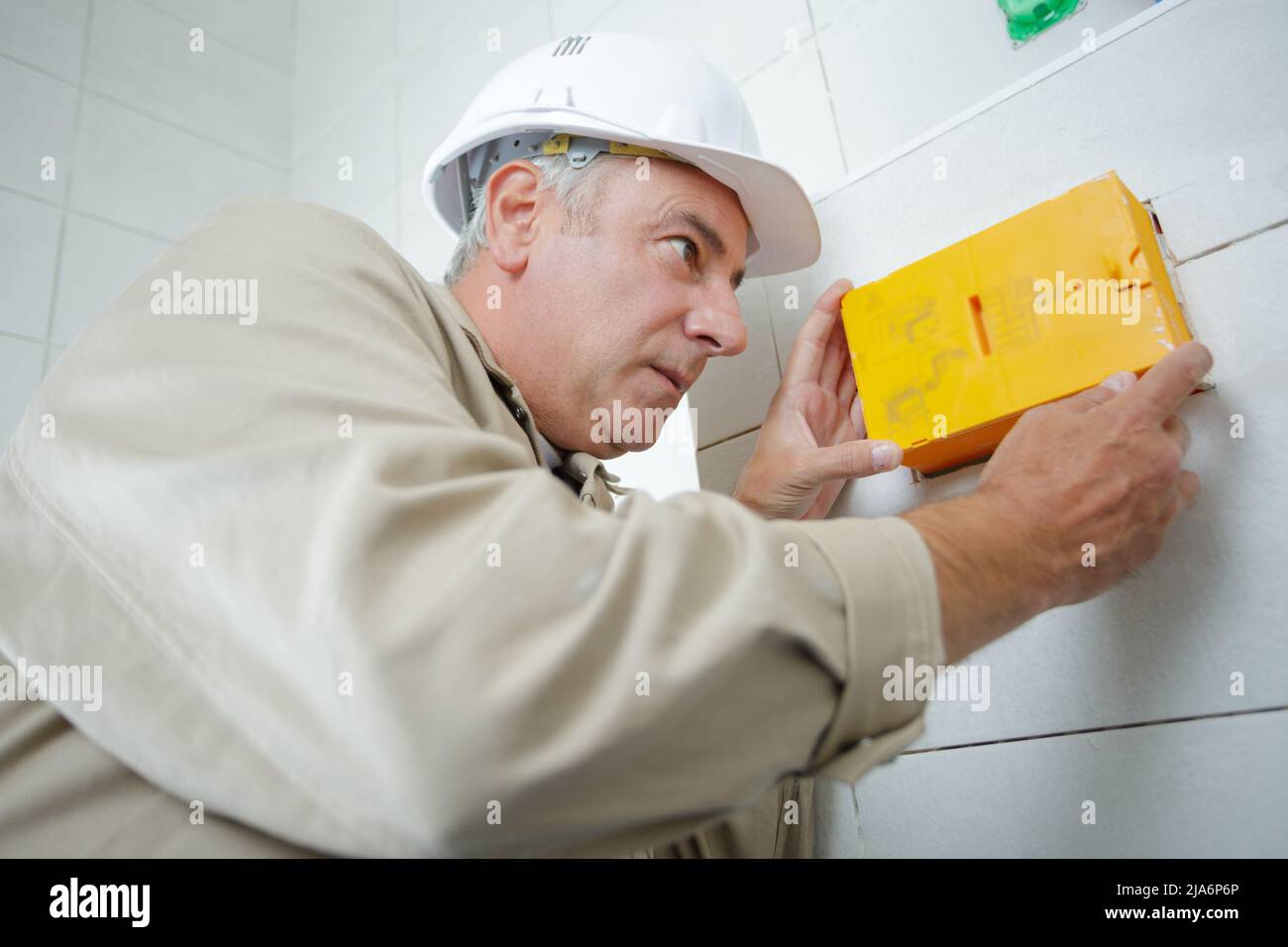 foreman and engineer wearing hardhat looking the electric breaker box ...