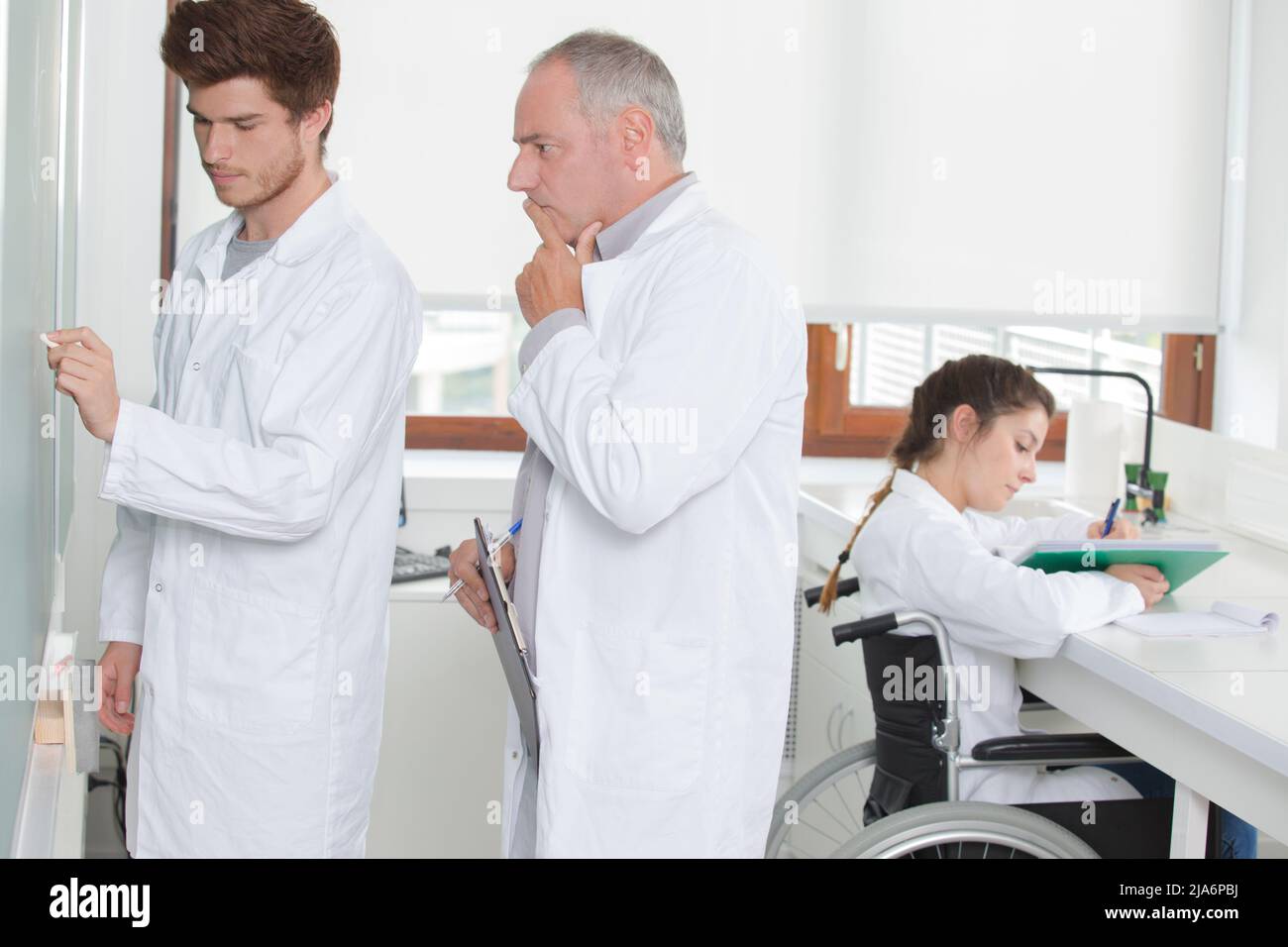 student working formula with teacher Stock Photo - Alamy