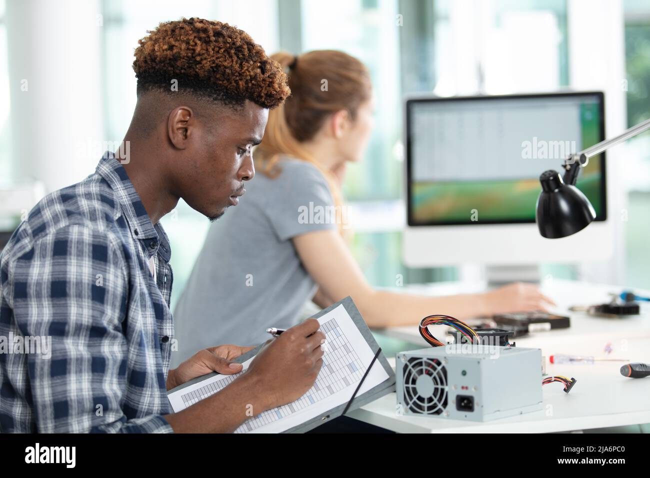 students preparing a pc for testing in workshop Stock Photo - Alamy