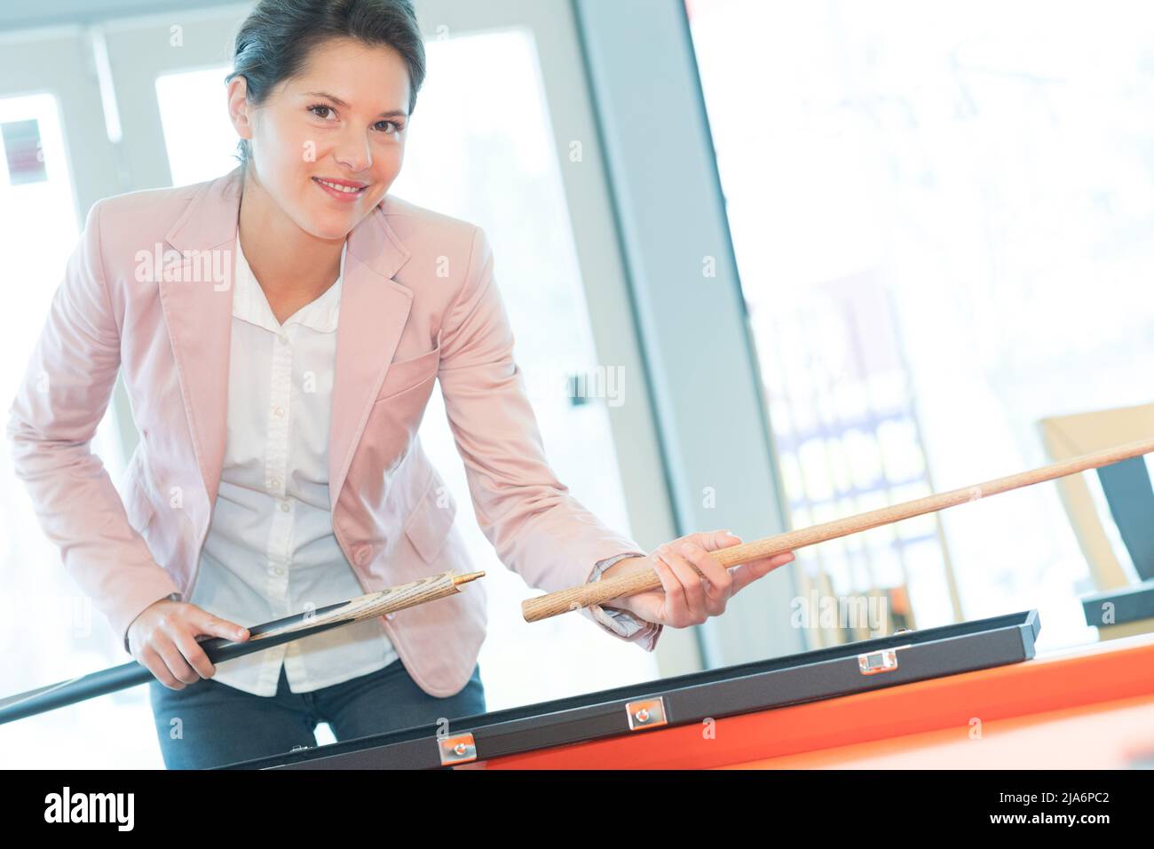 woman assembling two parts of snooker cue Stock Photo - Alamy
