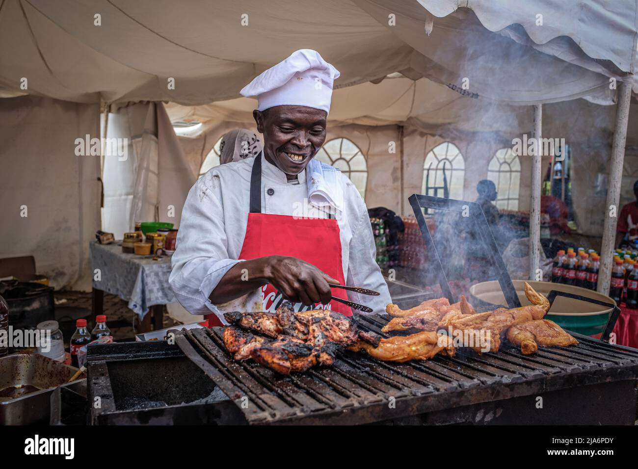 Nairobi, Kenya. 27th May, 2022. A chef grills chicken for sell during ...