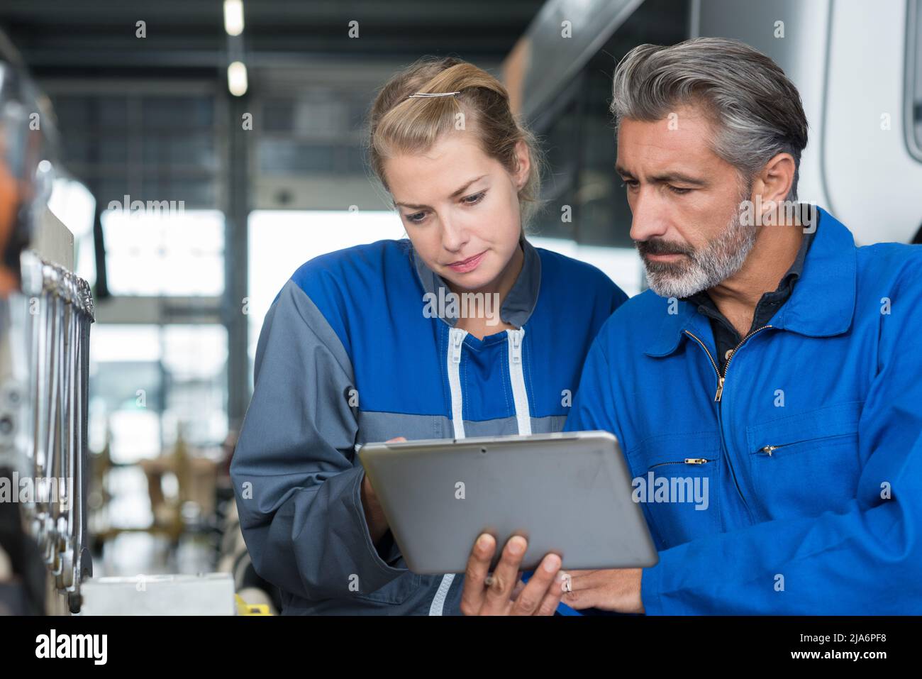 bus mechanics looking at tablet Stock Photo - Alamy