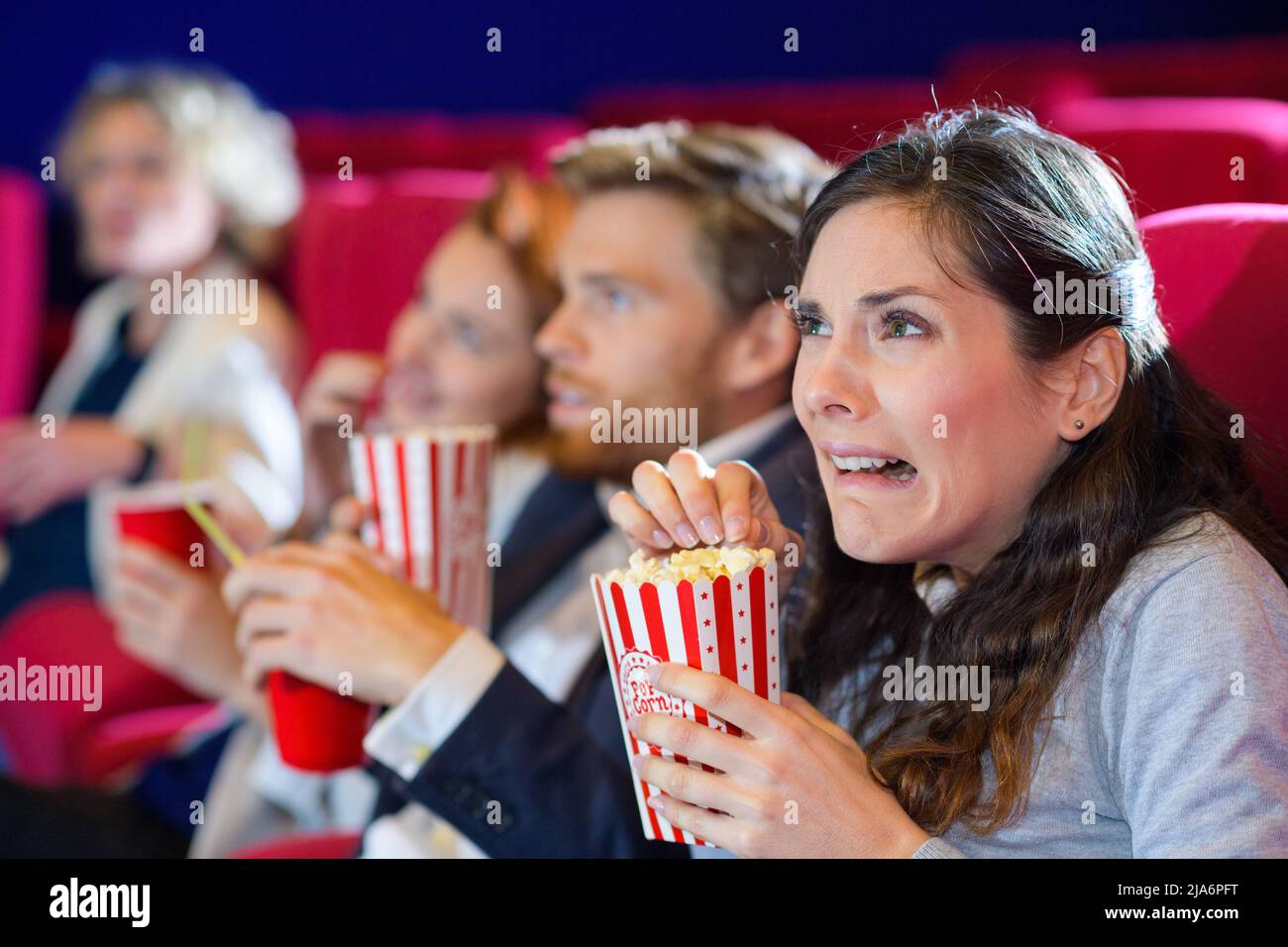 young people screaming while watching horror movie in the cineama Stock ...